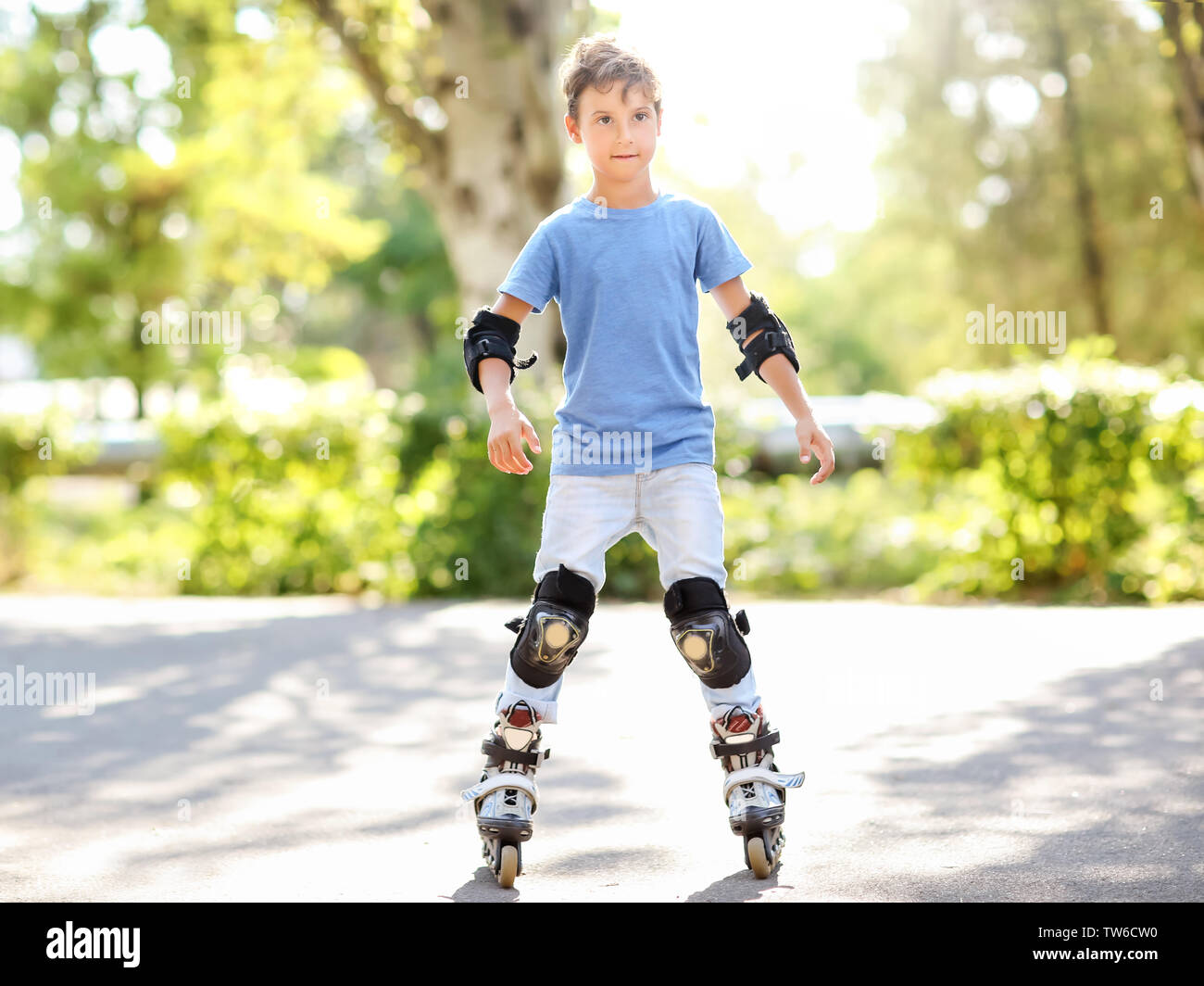 Cute boy rollerskating in park Stock Photo Alamy