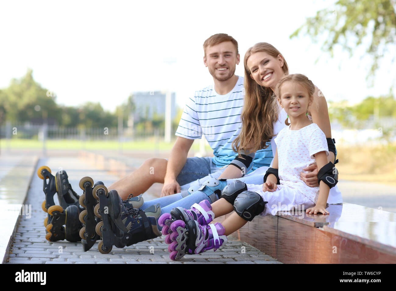 Family with roller skates in park Stock Photo - Alamy