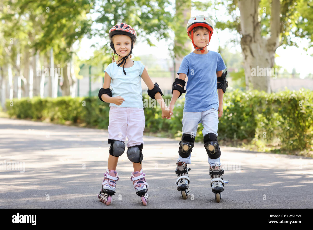 Cute children rollerskating in park Stock Photo - Alamy