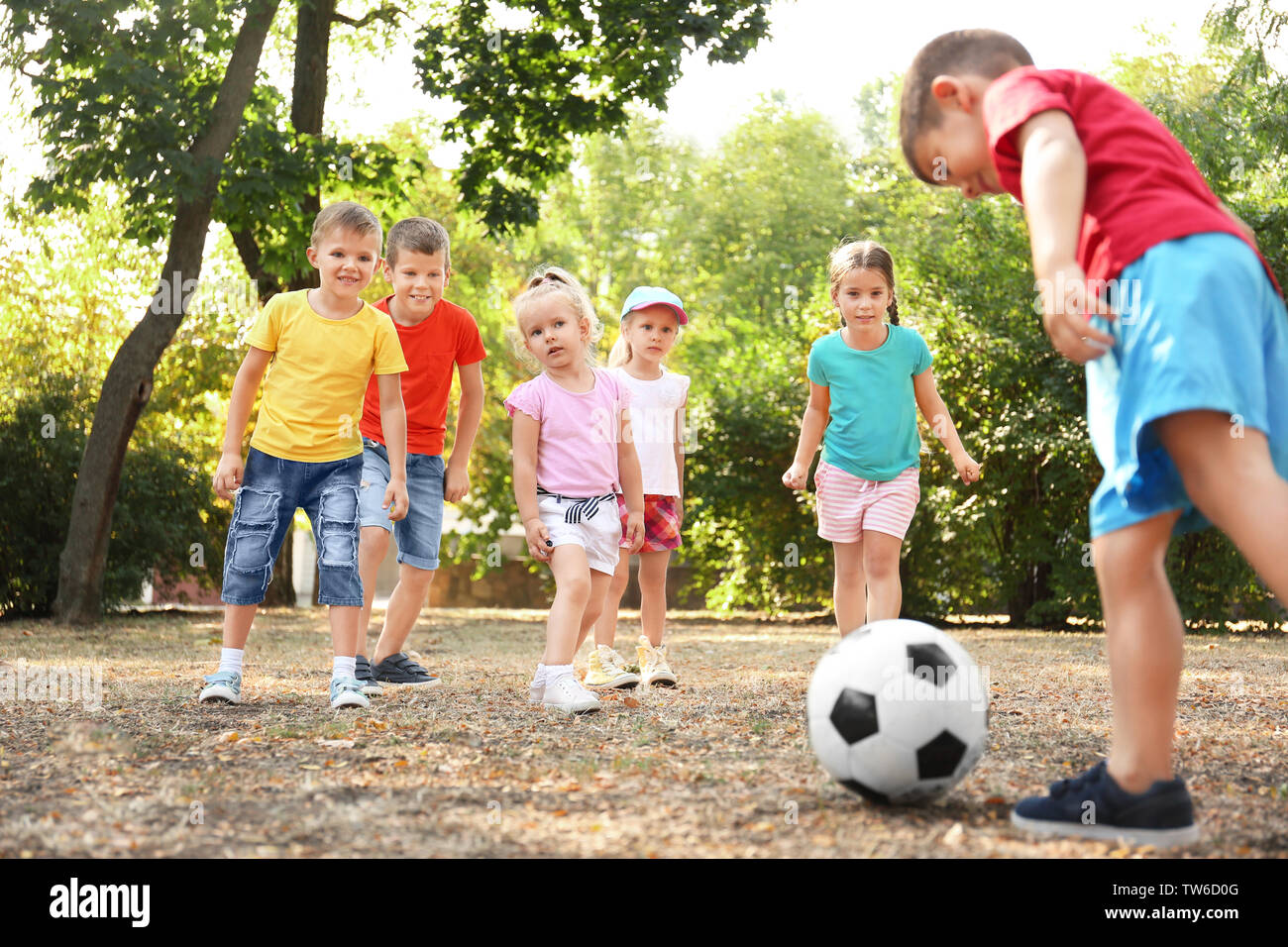 Cute children playing with ball in park Stock Photo - Alamy