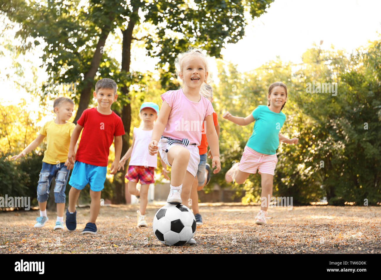 Cute children playing with ball in park Stock Photo - Alamy