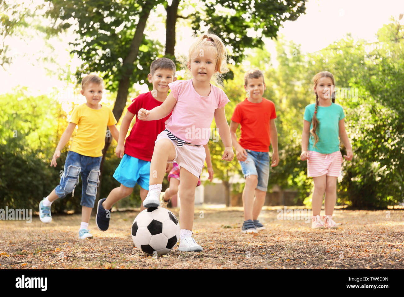Cute children playing with ball in park Stock Photo - Alamy