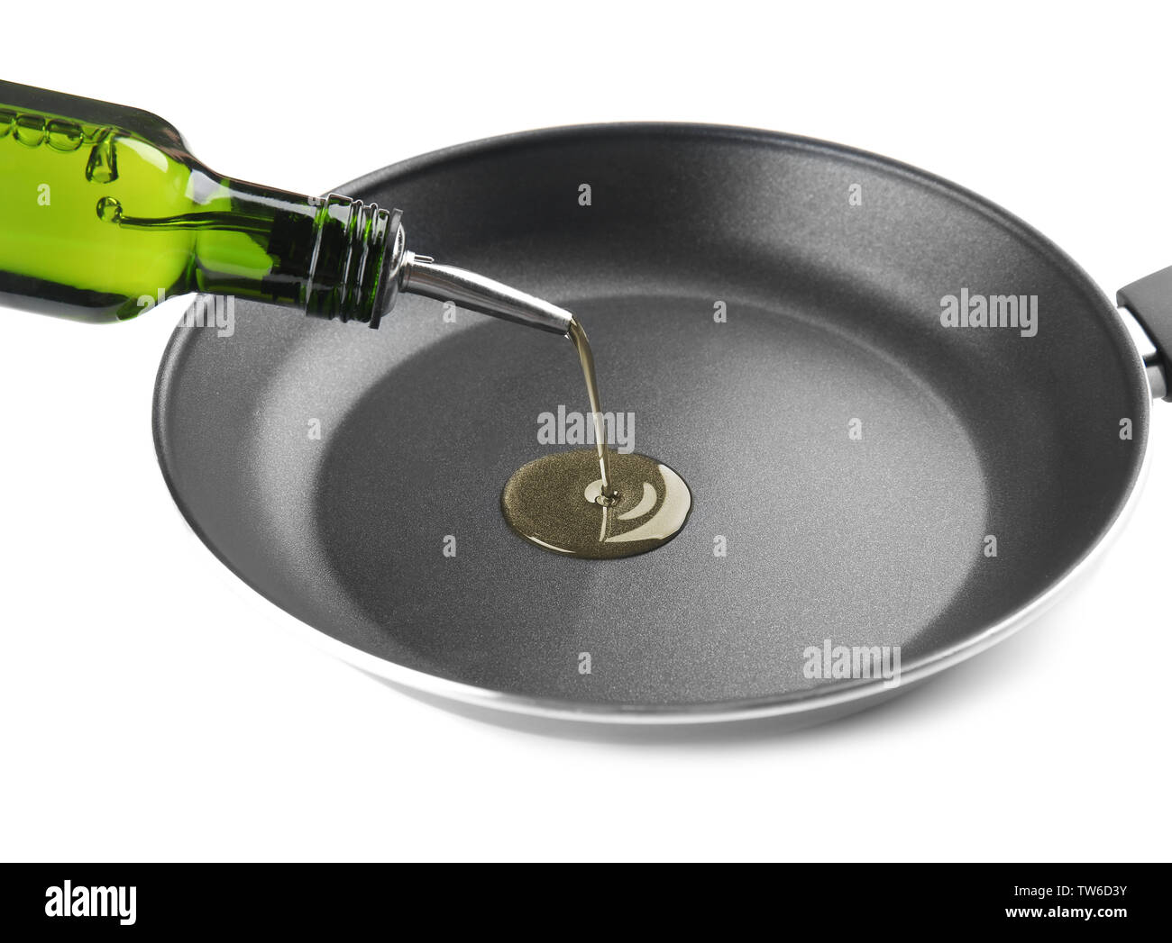 Pouring oil into frying pan on white background Stock Photo - Alamy