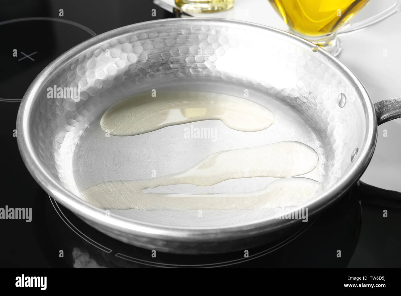 Frying pan with cooking oil on electric cooker Stock Photo - Alamy
