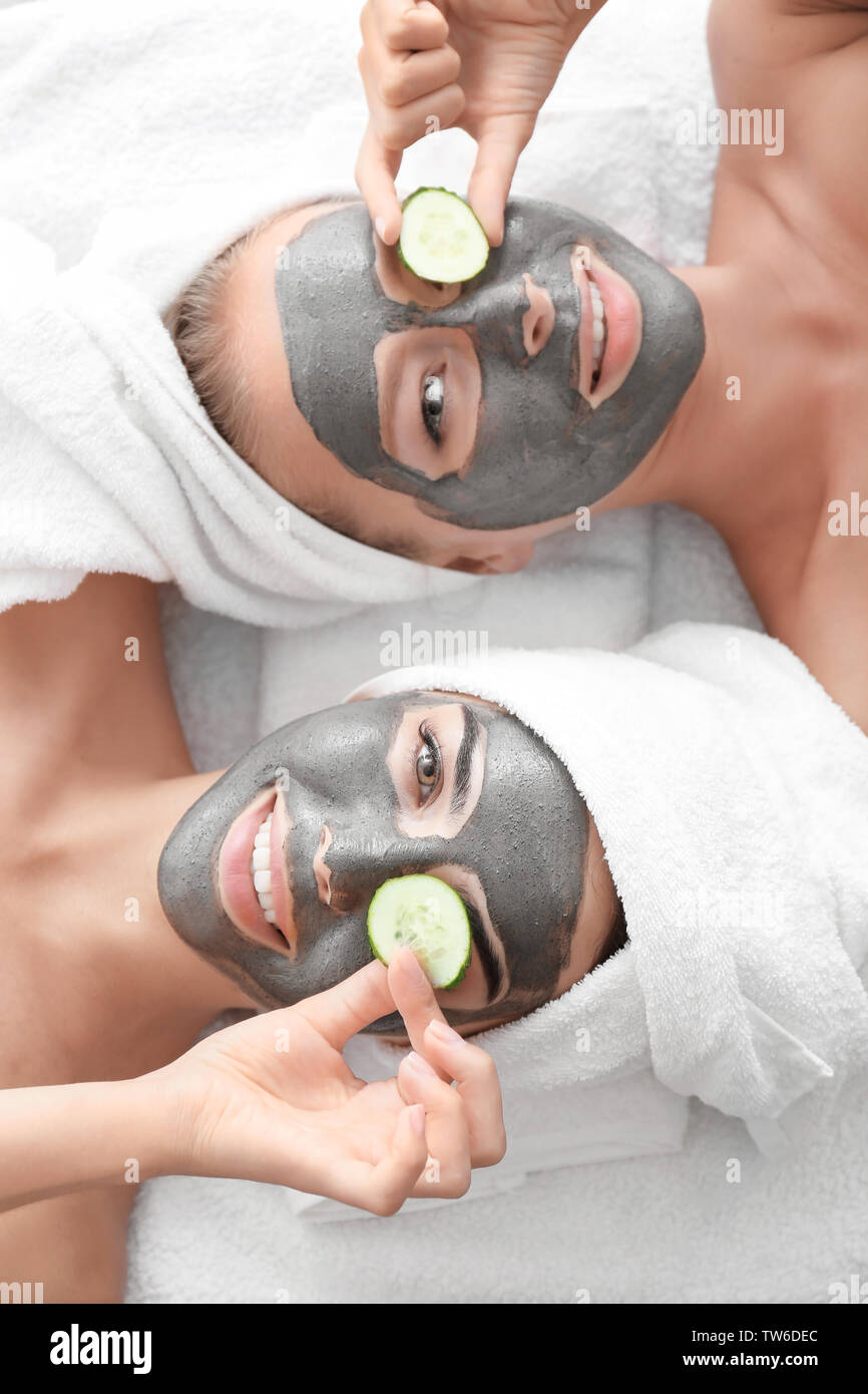Young women with facial masks and cucumber slices in spa salon Stock ...
