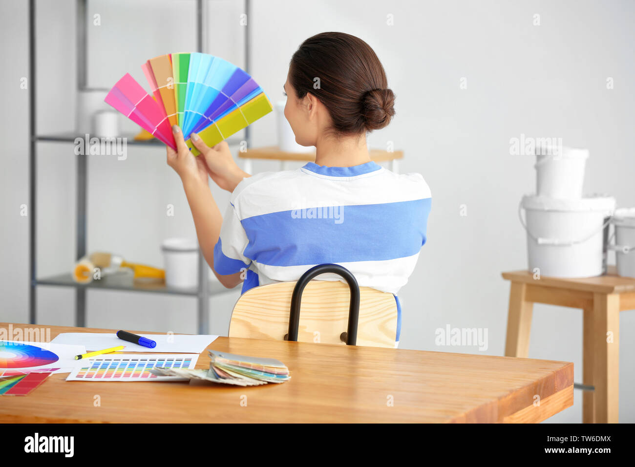 Female decorator holding color palette samples in office Stock Photo ...