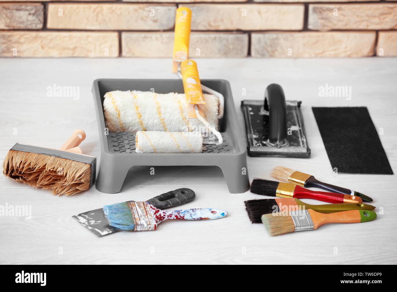 Different painting tools on wooden floor indoors Stock Photo - Alamy