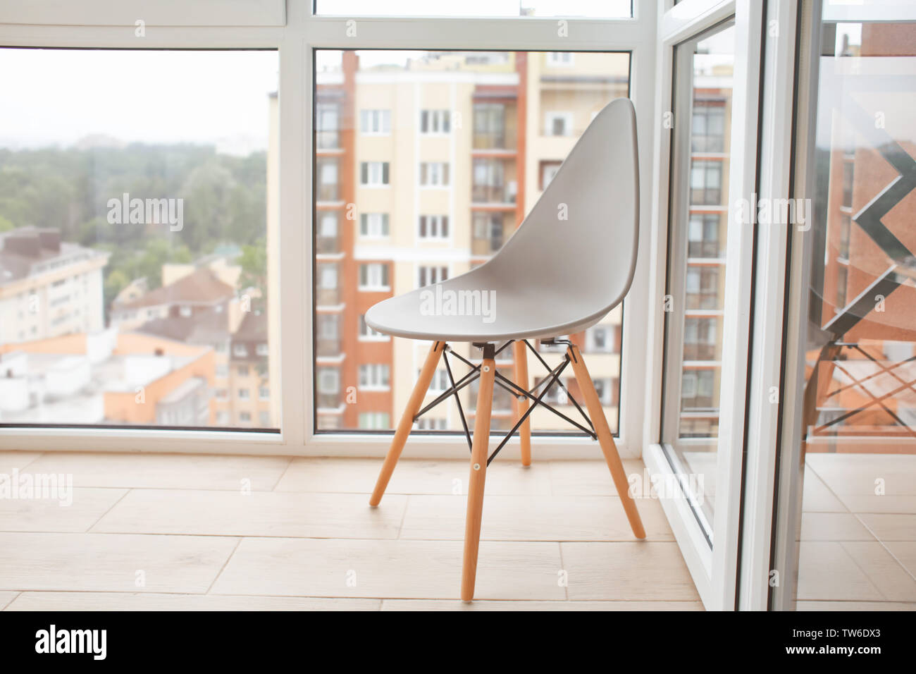Modern chair on balcony Stock Photo - Alamy