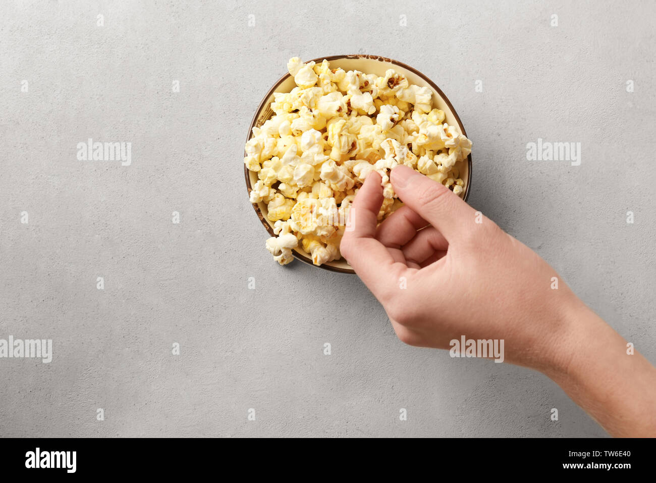 Woman taking delicious popcorn hi-res stock photography and images - Alamy