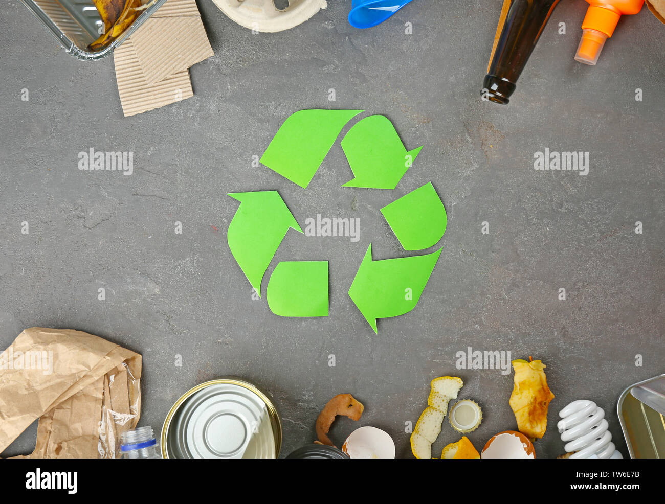 Recycling sign and garbage on textured background Stock Photo - Alamy