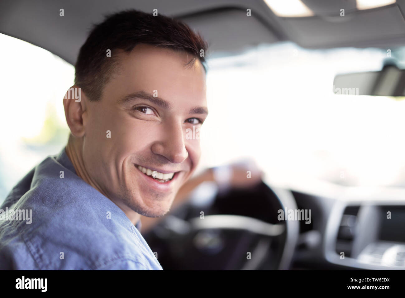 Happy man driving a car Stock Photo - Alamy