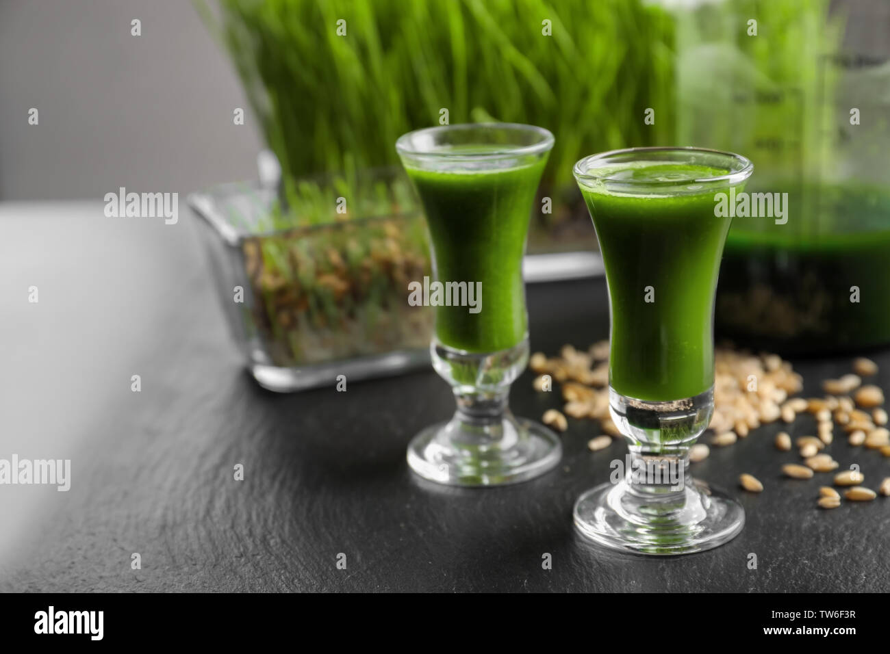 Shots of healthy wheat grass juice on slate plate Stock Photo - Alamy