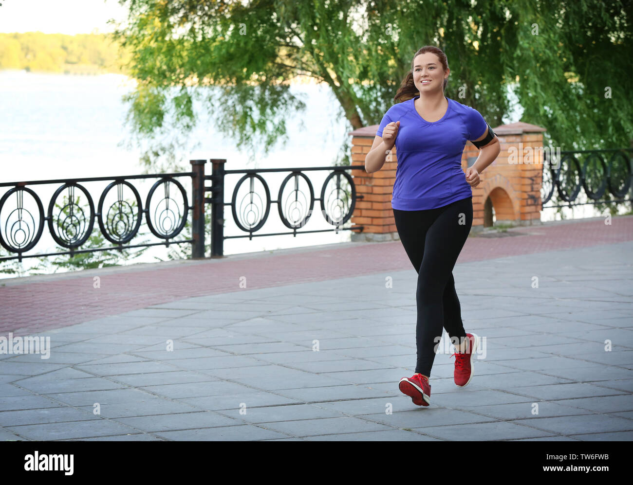 Woman overweight running in park hi-res stock photography and images ...