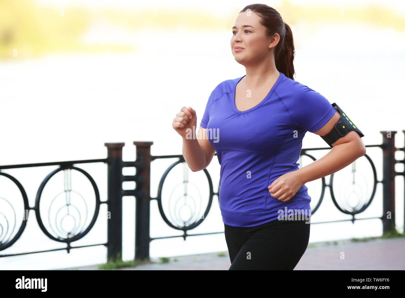 Young woman jogging near river hi-res stock photography and images - Alamy