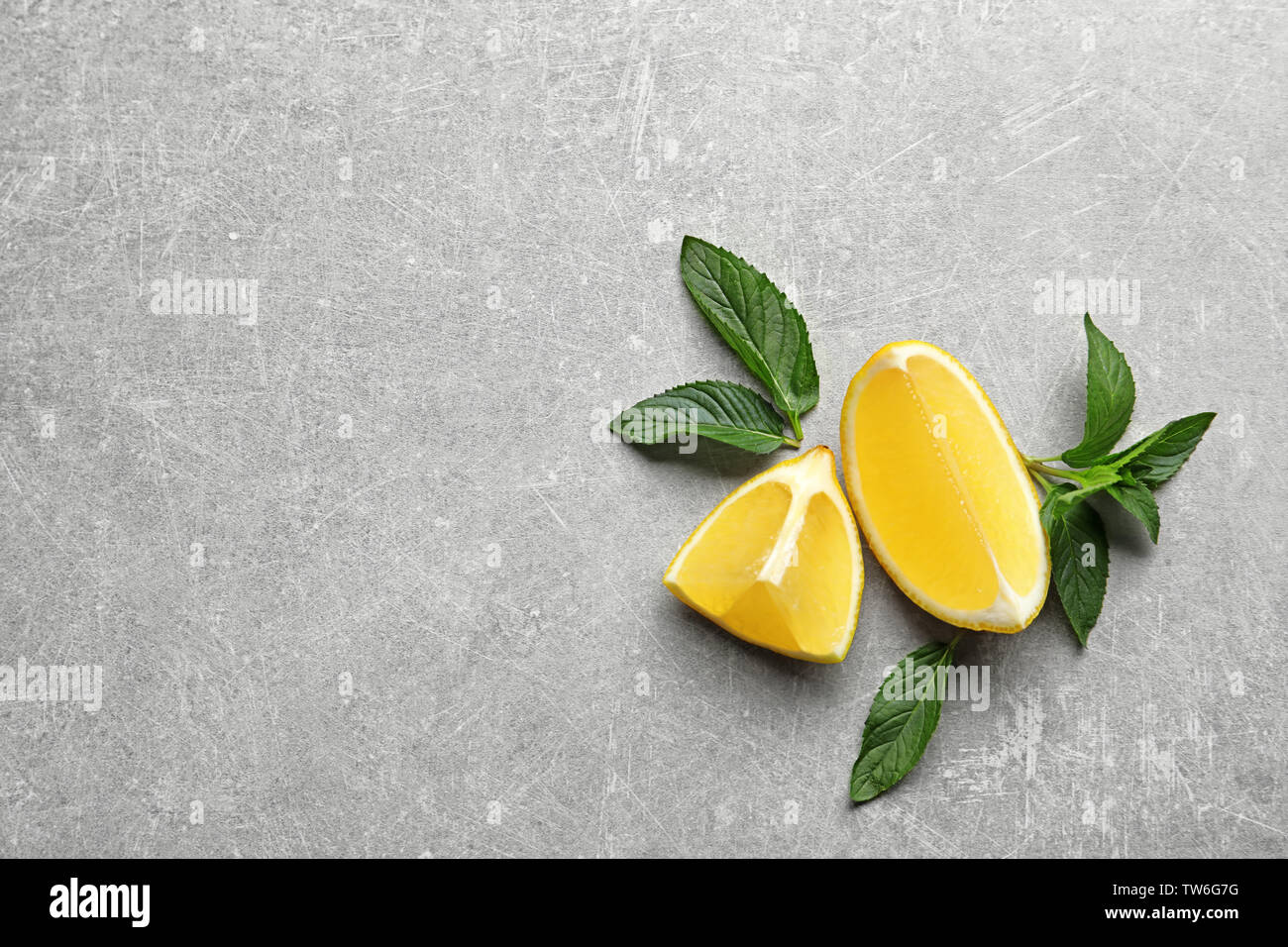 Mint and lemon on grey background Stock Photo - Alamy