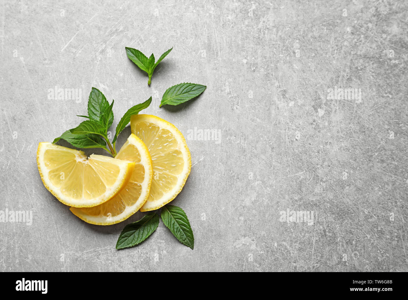 Mint and lemon on grey background Stock Photo - Alamy