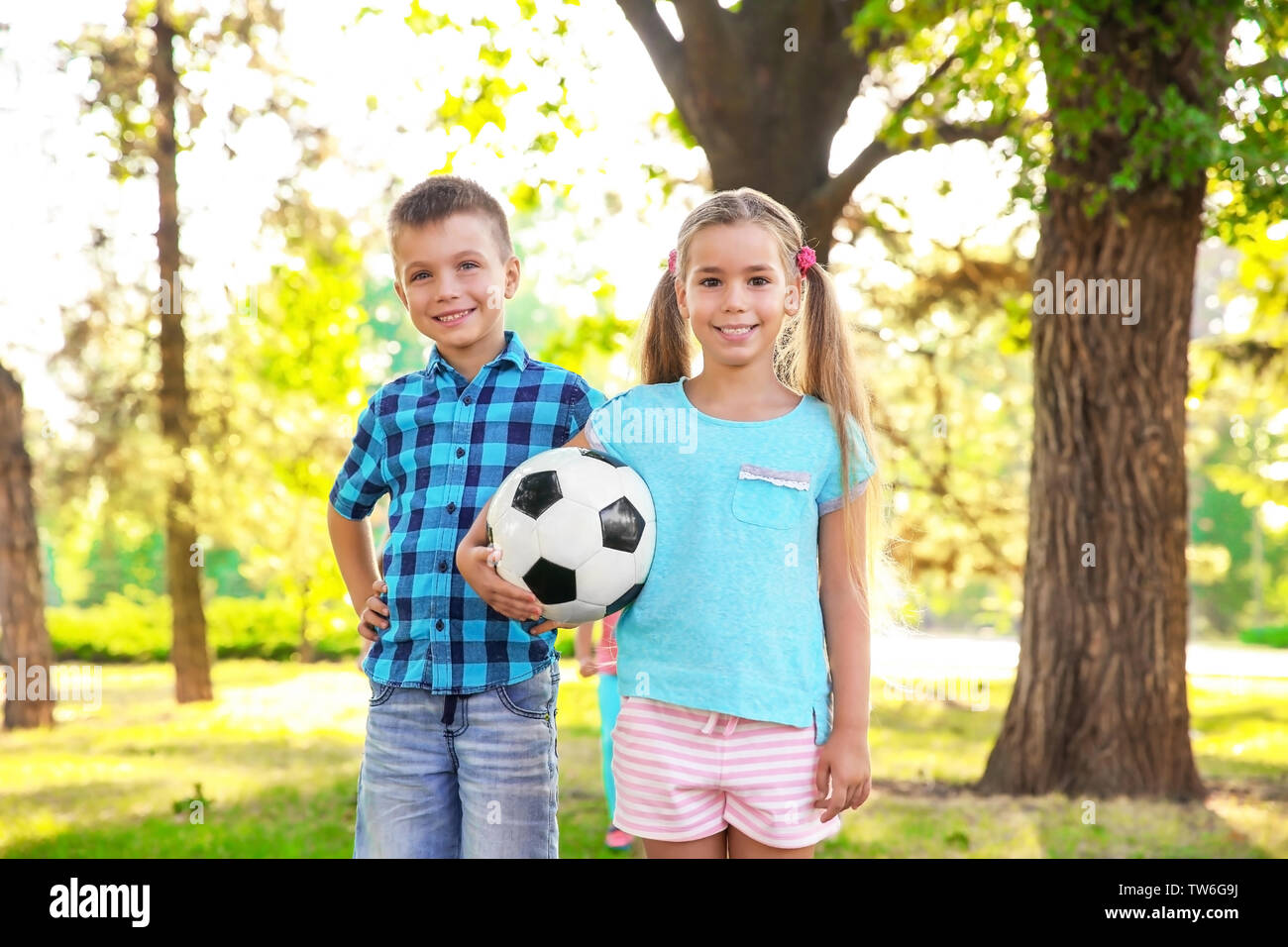 Cute little children with ball in park Stock Photo - Alamy