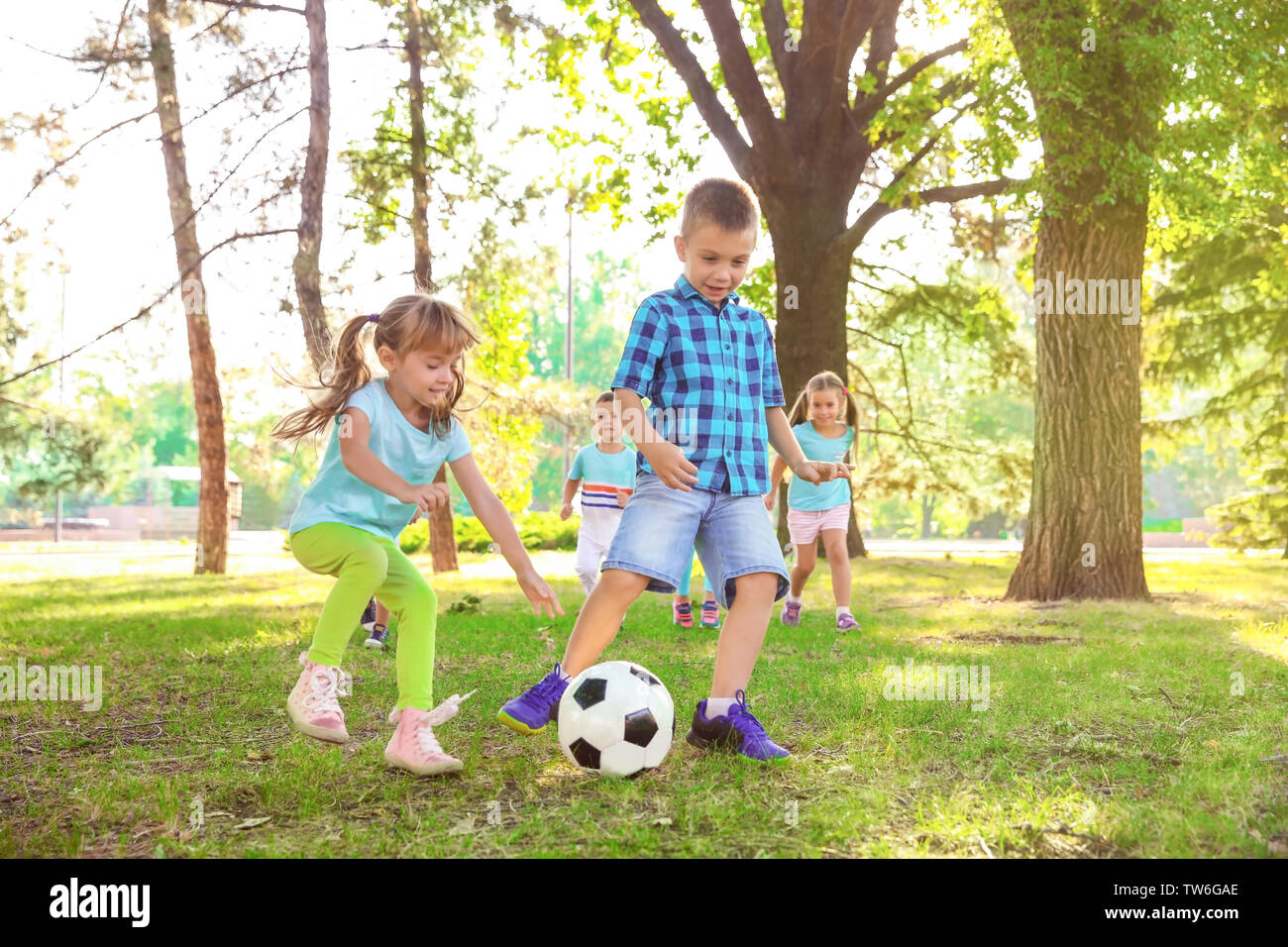 Cute little children playing with ball in park Stock Photo - Alamy
