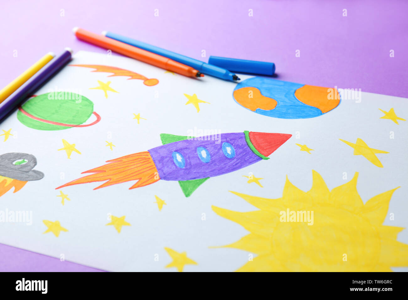 Child's drawing of rocket in space on color background, closeup Stock ...