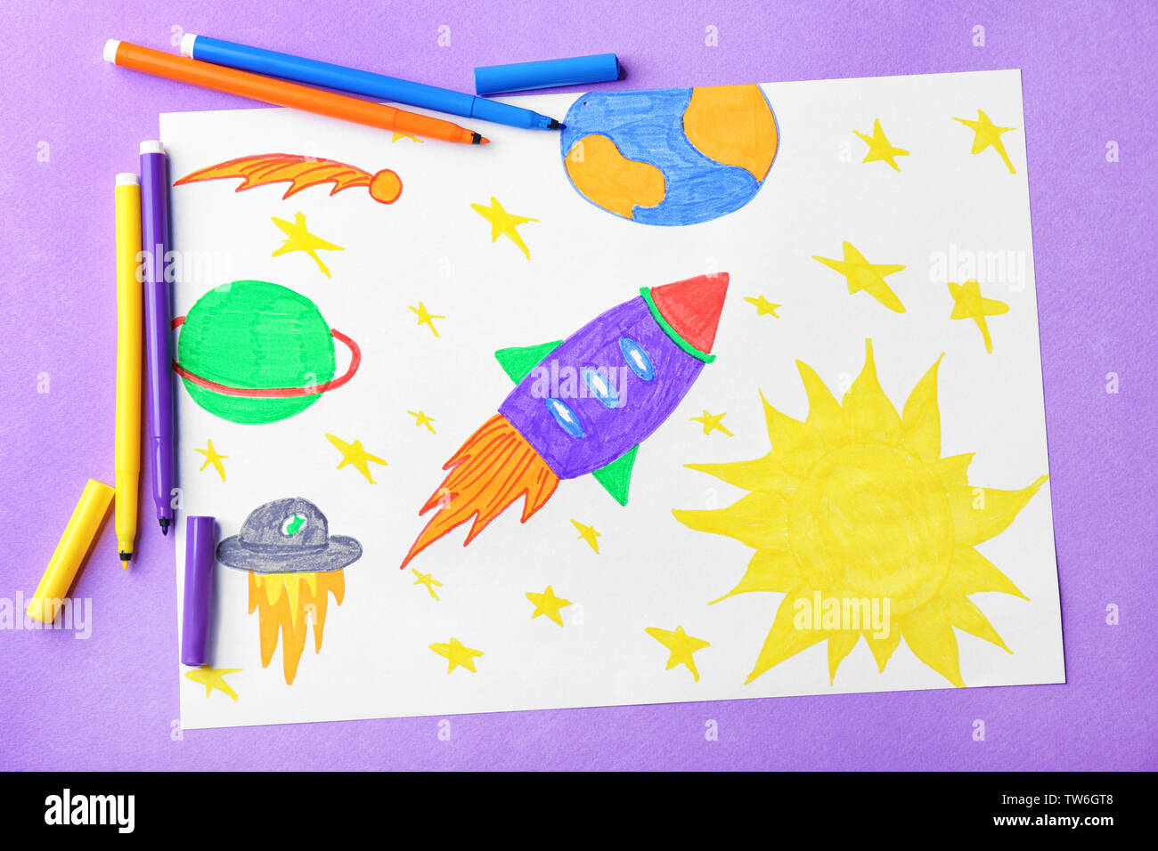 Child's drawing of rocket in space on violet background Stock Photo - Alamy