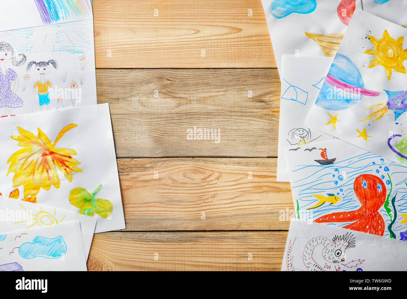 Children's drawings on wooden background Stock Photo - Alamy