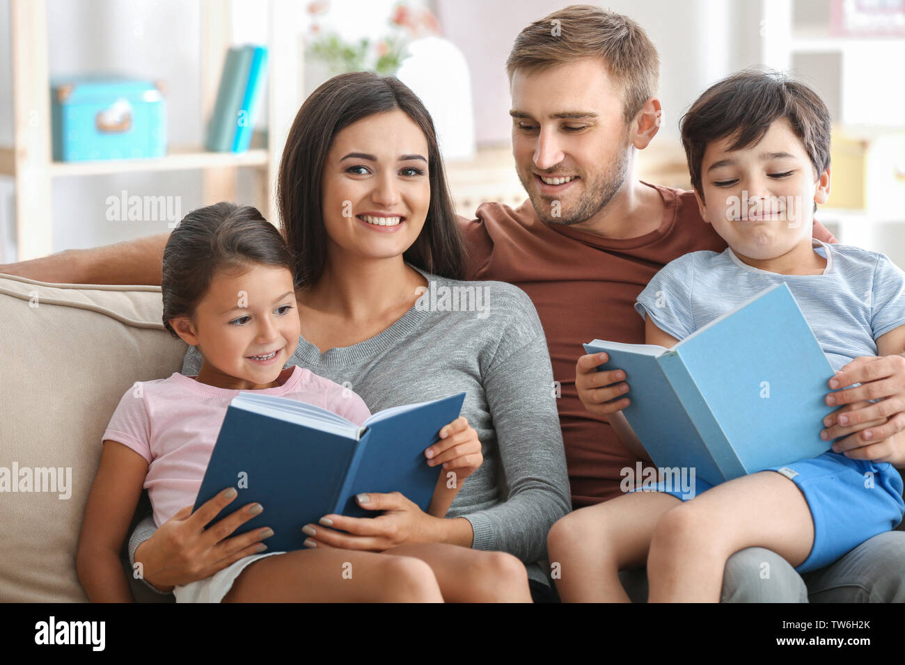 Happy family reading books at home Stock Photo - Alamy