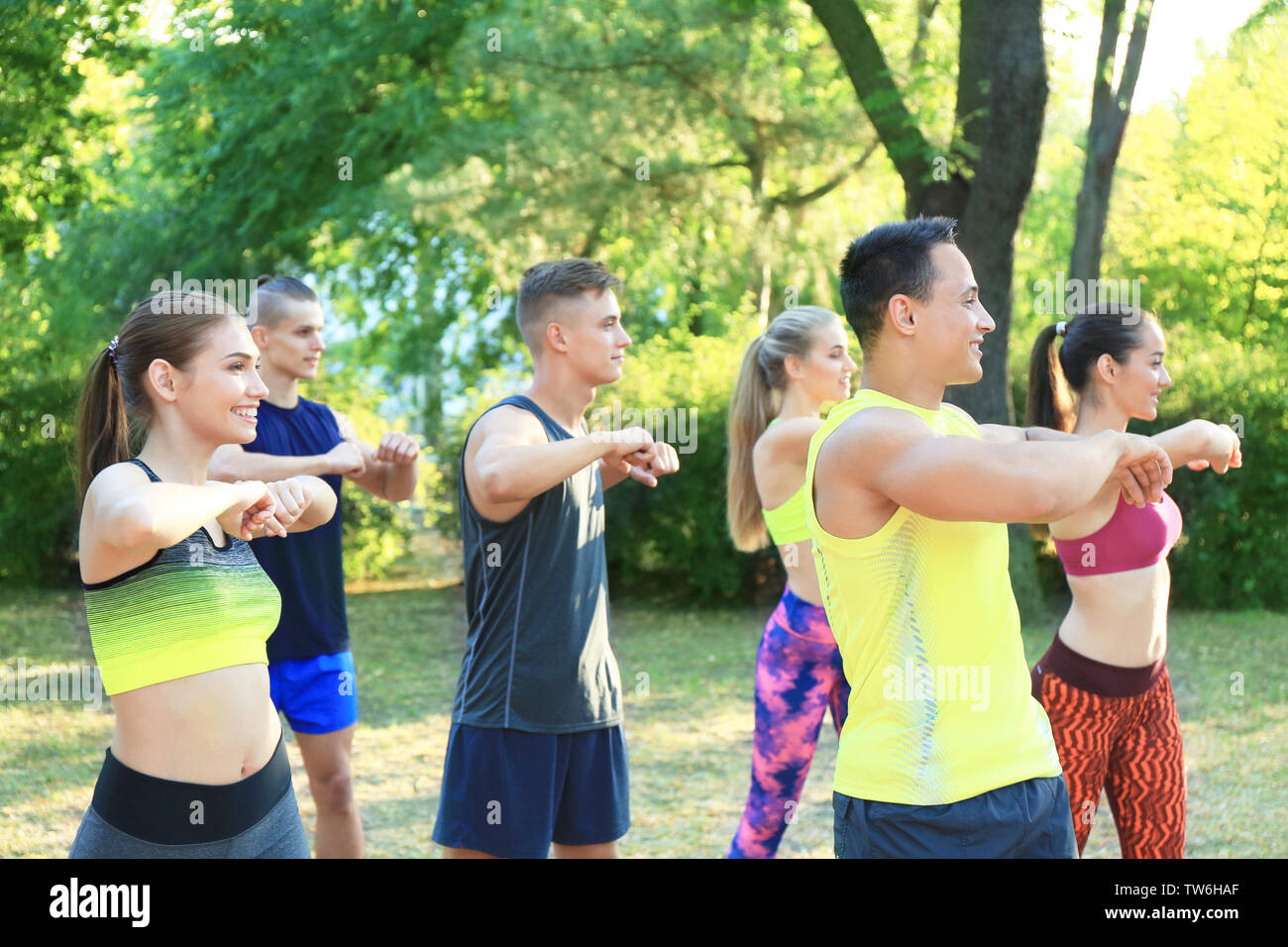Group of young people doing exercise outdoor Stock Photo - Alamy