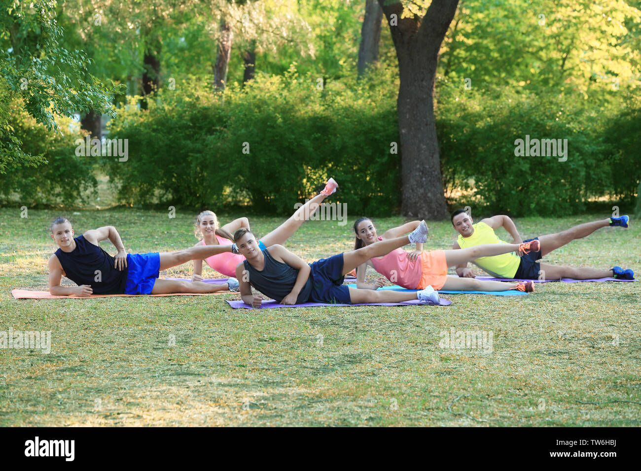 Group of young people doing exercise outdoor Stock Photo - Alamy