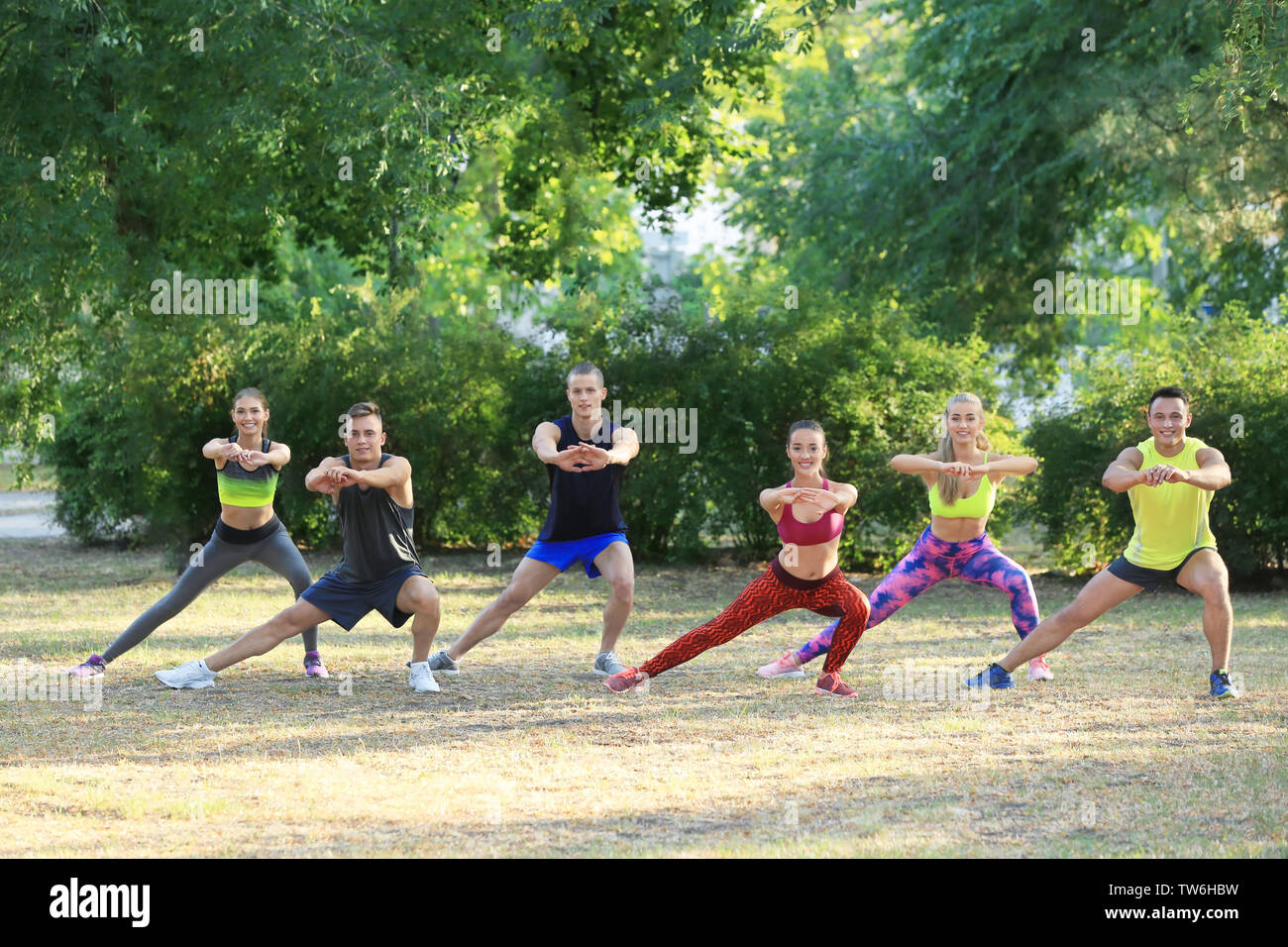 Group of young people doing exercise outdoor Stock Photo - Alamy