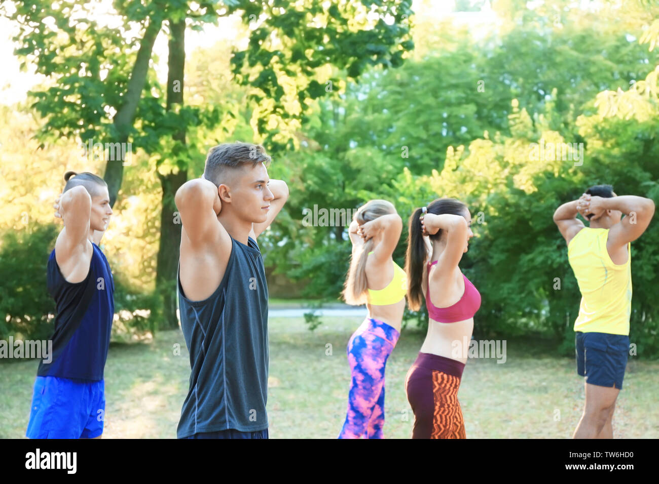 Group of young people doing exercise outdoor Stock Photo - Alamy