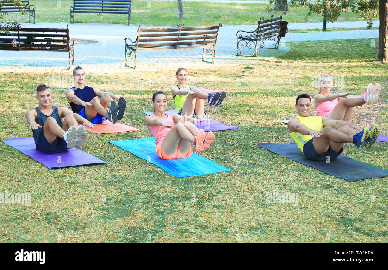 Group of young people doing exercise outdoor Stock Photo - Alamy