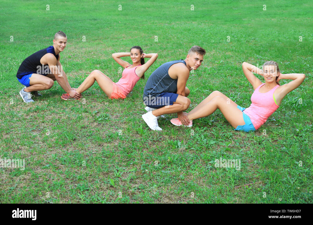 Group of young people doing exercise outdoor Stock Photo - Alamy