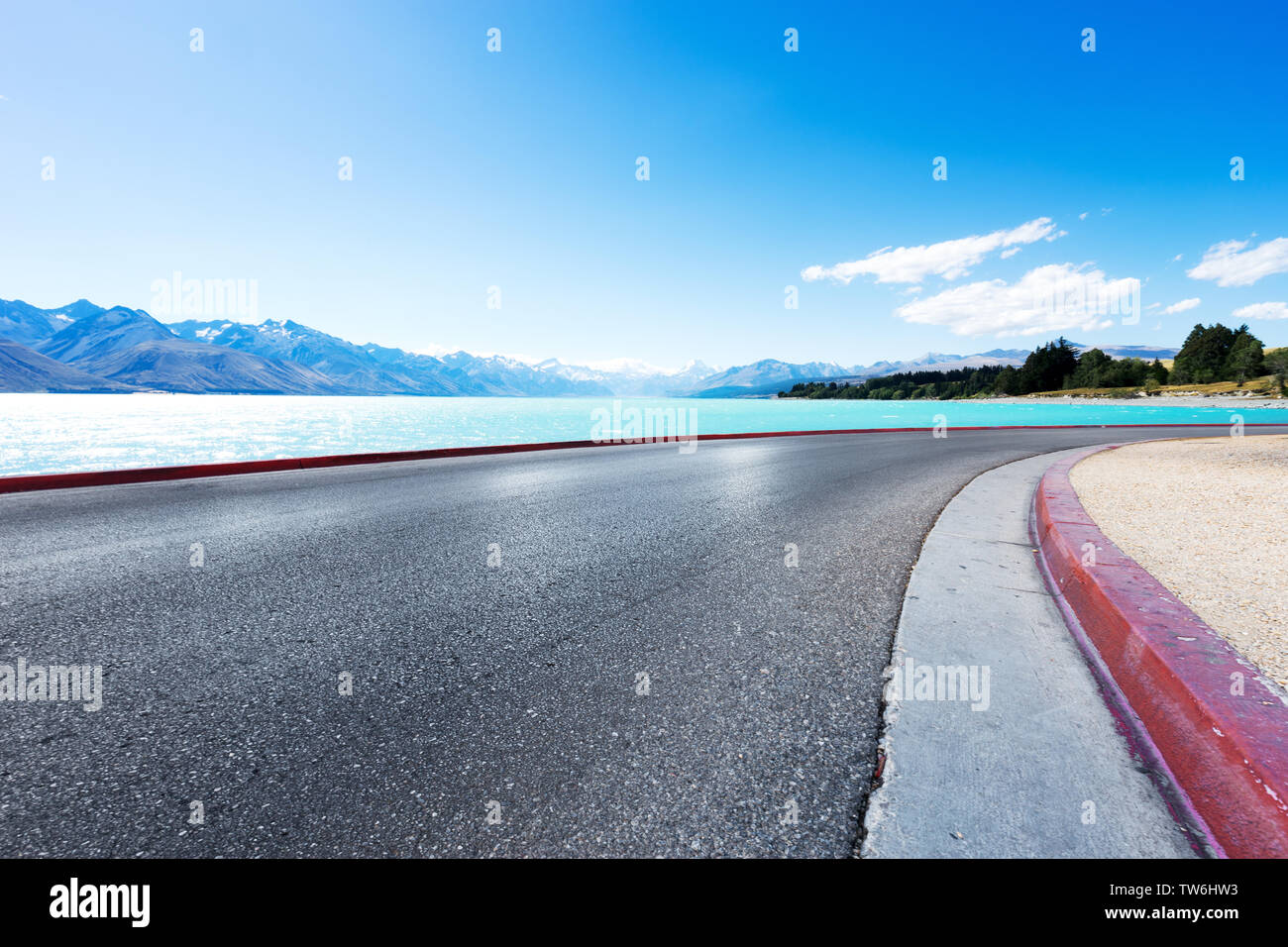 empty road with beautiful blue lake in blue sky Stock Photo - Alamy