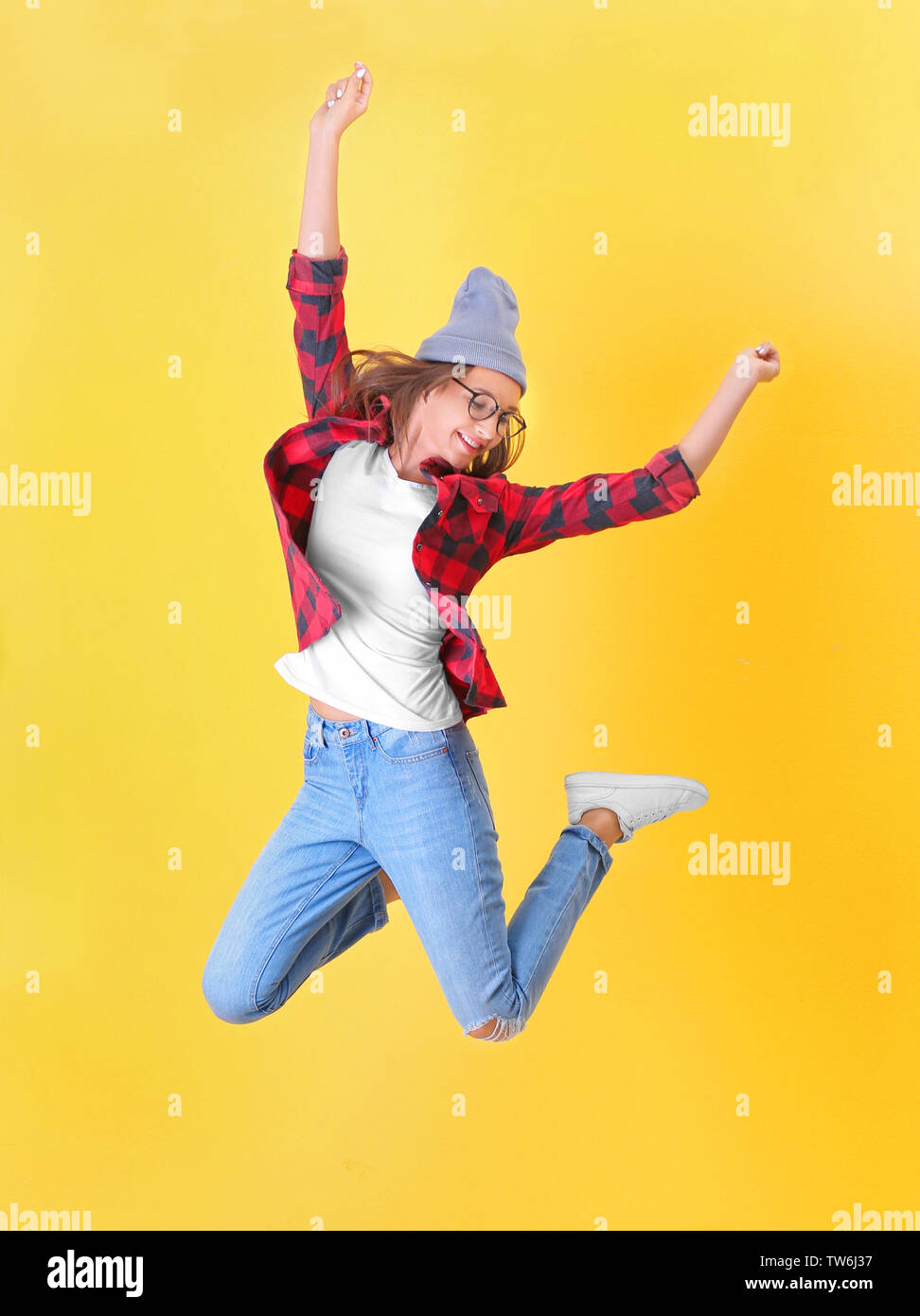 Jumping teenager girl on color background Stock Photo - Alamy