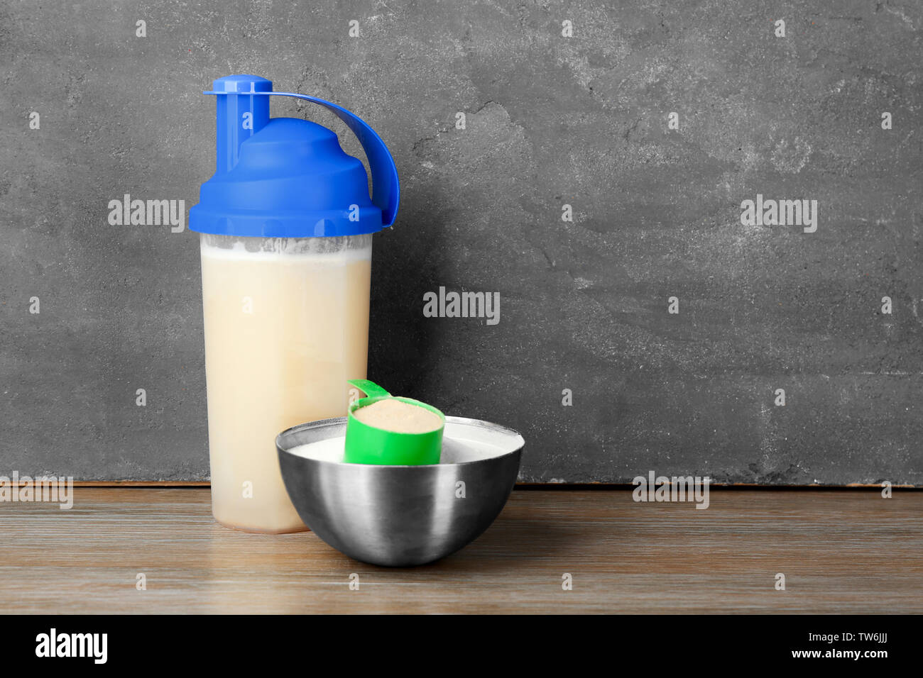 Bottle of protein shake and powder on table Stock Photo - Alamy