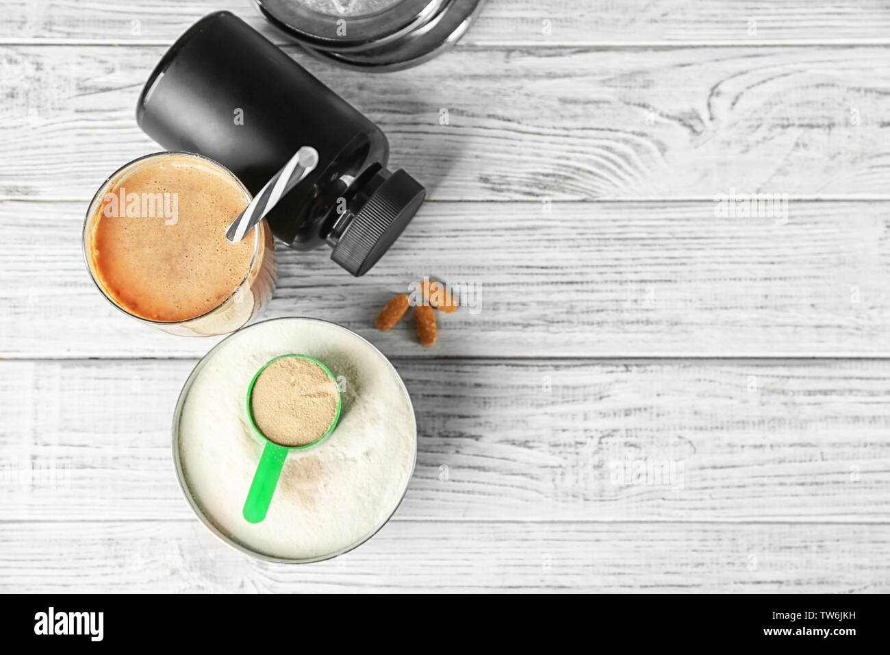 Glass with protein shake and powder on table Stock Photo - Alamy