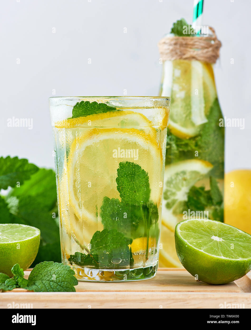 summer refreshing drink lemonade with lemons, mint leaves, lime in a ...