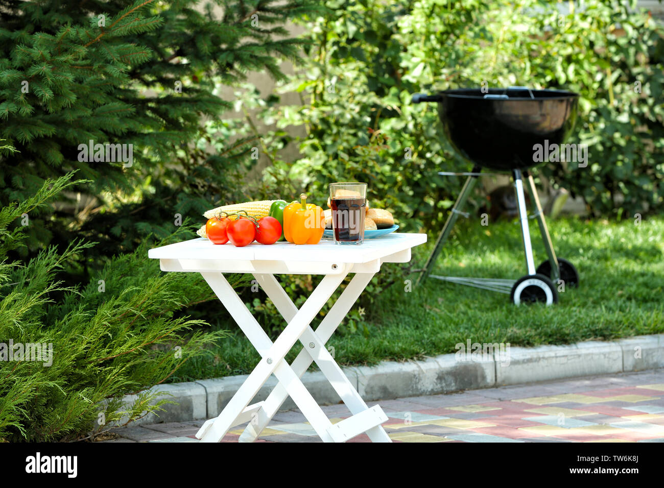 Wooden table with food on backyard Stock Photo - Alamy