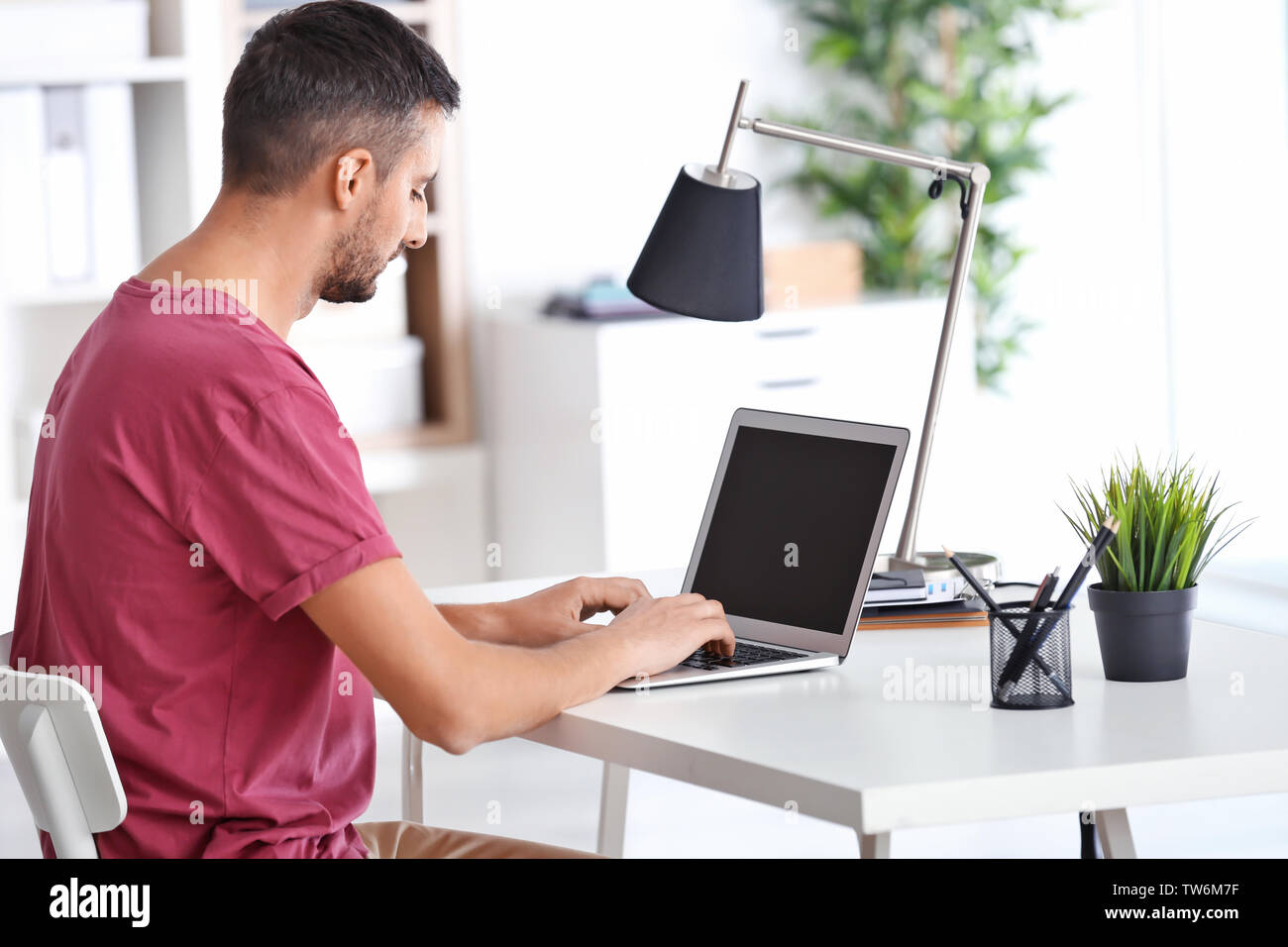 Male programmer working in office Stock Photo - Alamy