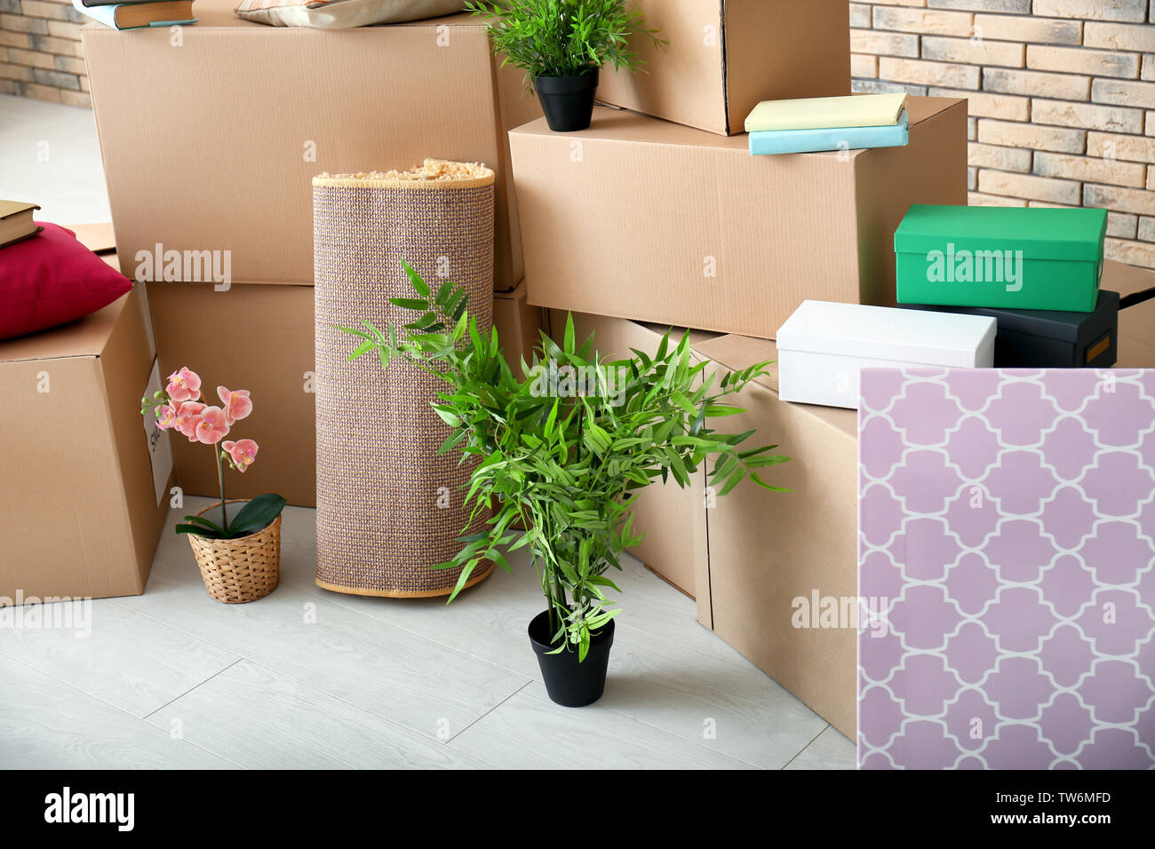 Carton boxes and interior items on floor in room. Moving house concept ...