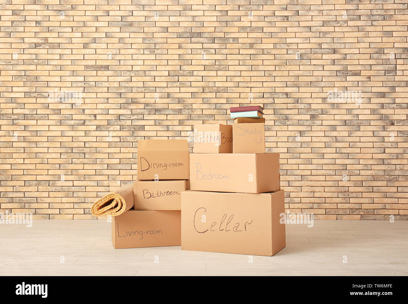 Carton boxes on floor in room. Moving house concept Stock Photo - Alamy