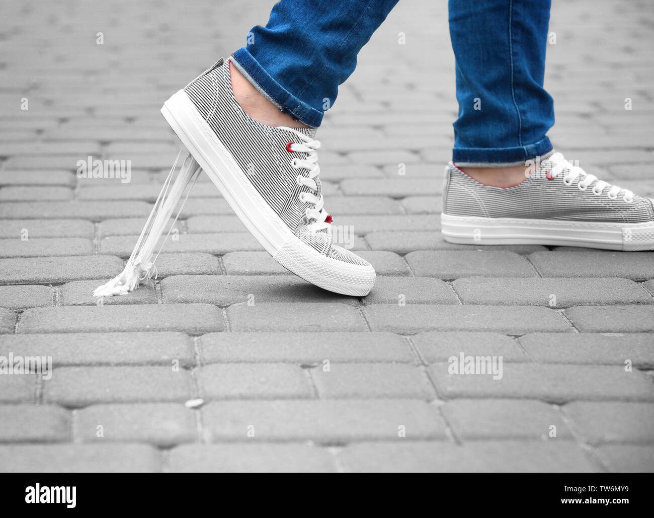Foot stuck into chewing gum on street. Concept of stickiness Stock ...