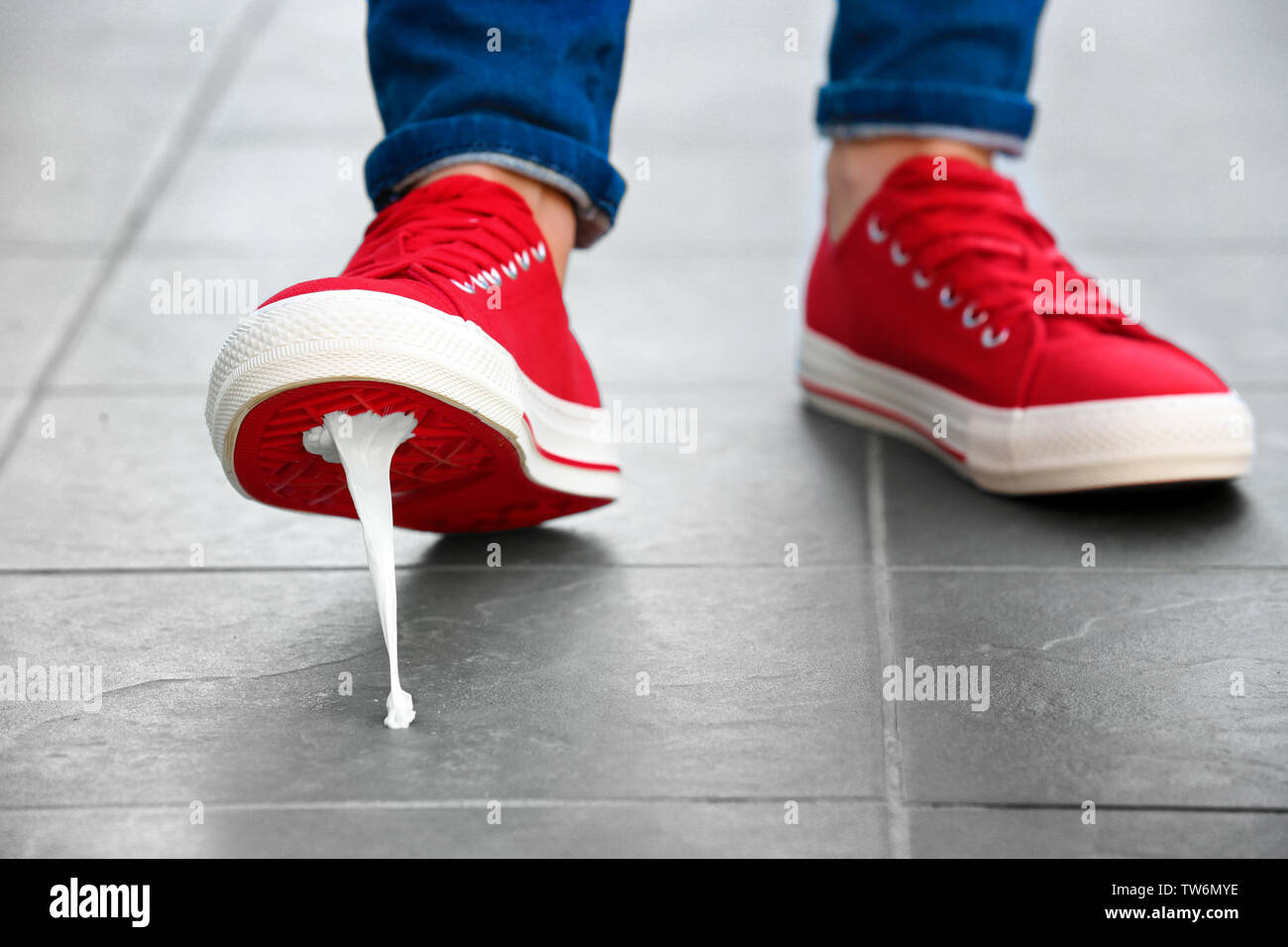 Foot stuck into chewing gum on street. Concept of stickiness Stock ...