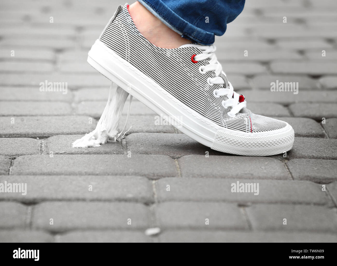 Foot stuck into chewing gum on street. Concept of stickiness Stock ...