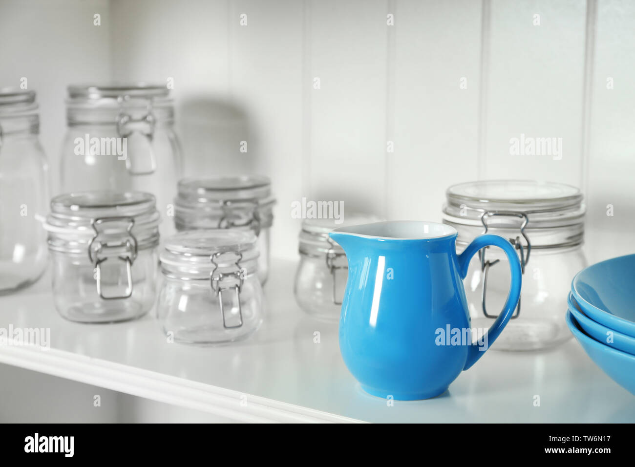 White storage stand with glassware in kitchen Stock Photo - Alamy