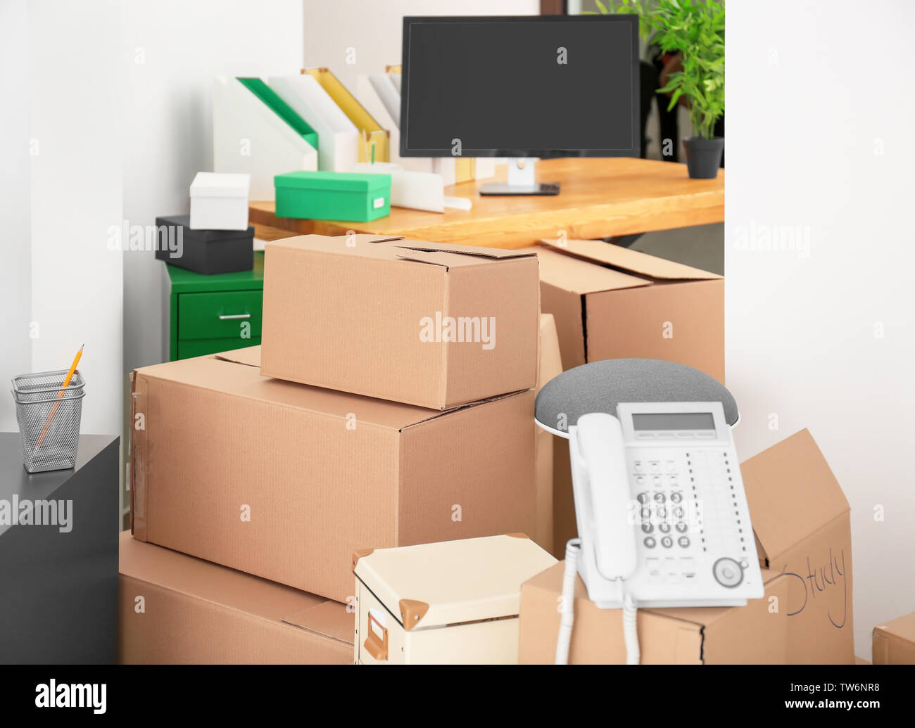 Moving boxes and different stuff in new office Stock Photo - Alamy