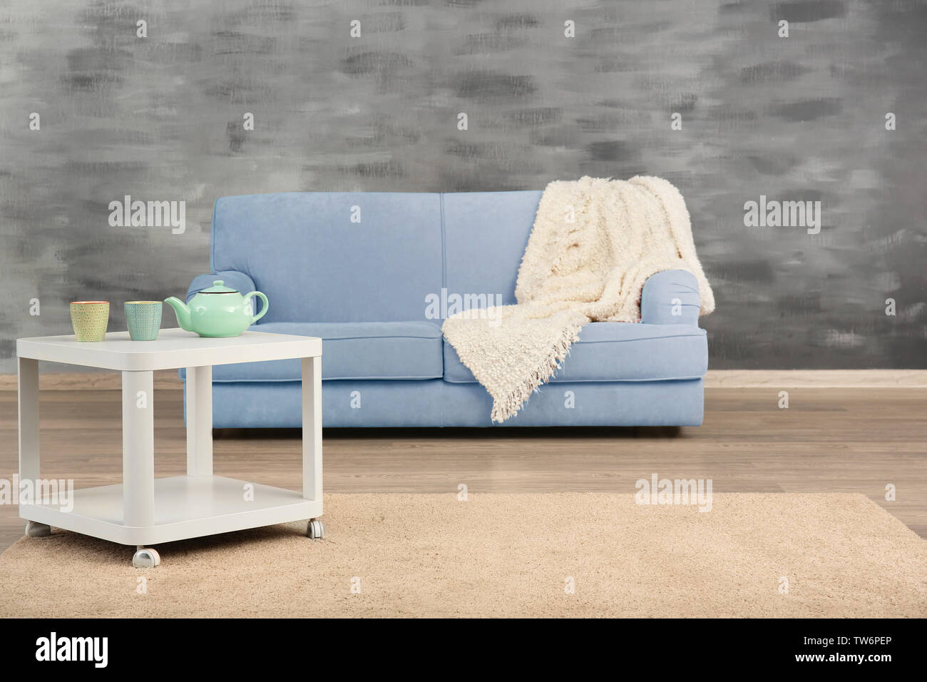 Modern living room with cozy sofa Stock Photo - Alamy