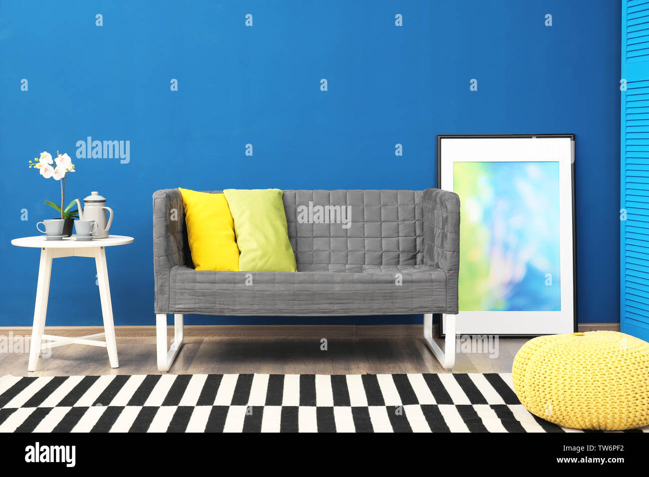 Modern living room with cozy sofa Stock Photo - Alamy