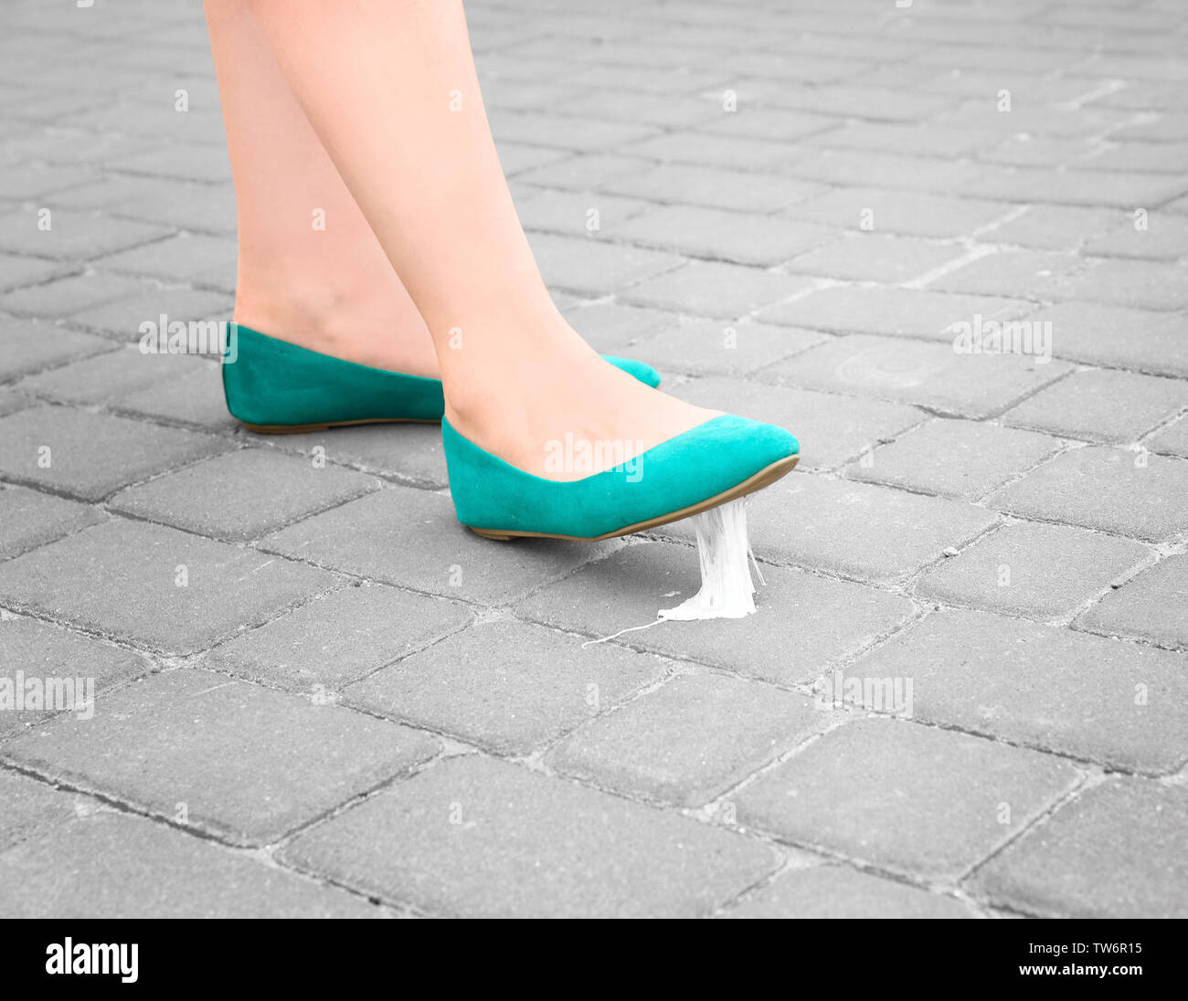 Female foot stuck into chewing gum on street. Concept of stickiness ...
