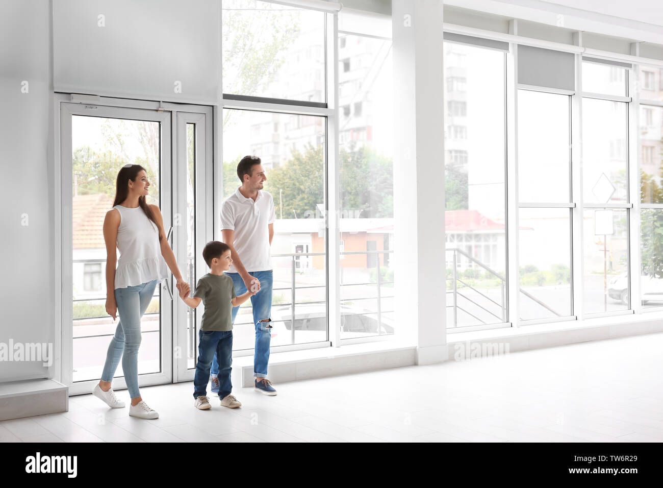 Happy family entering new house Stock Photo - Alamy